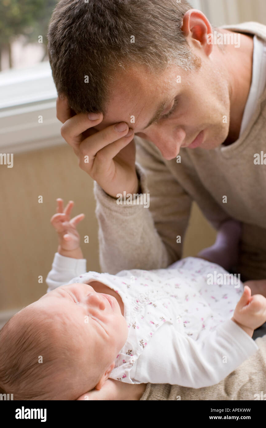 stressed father with crying baby Stock Photo - Alamy