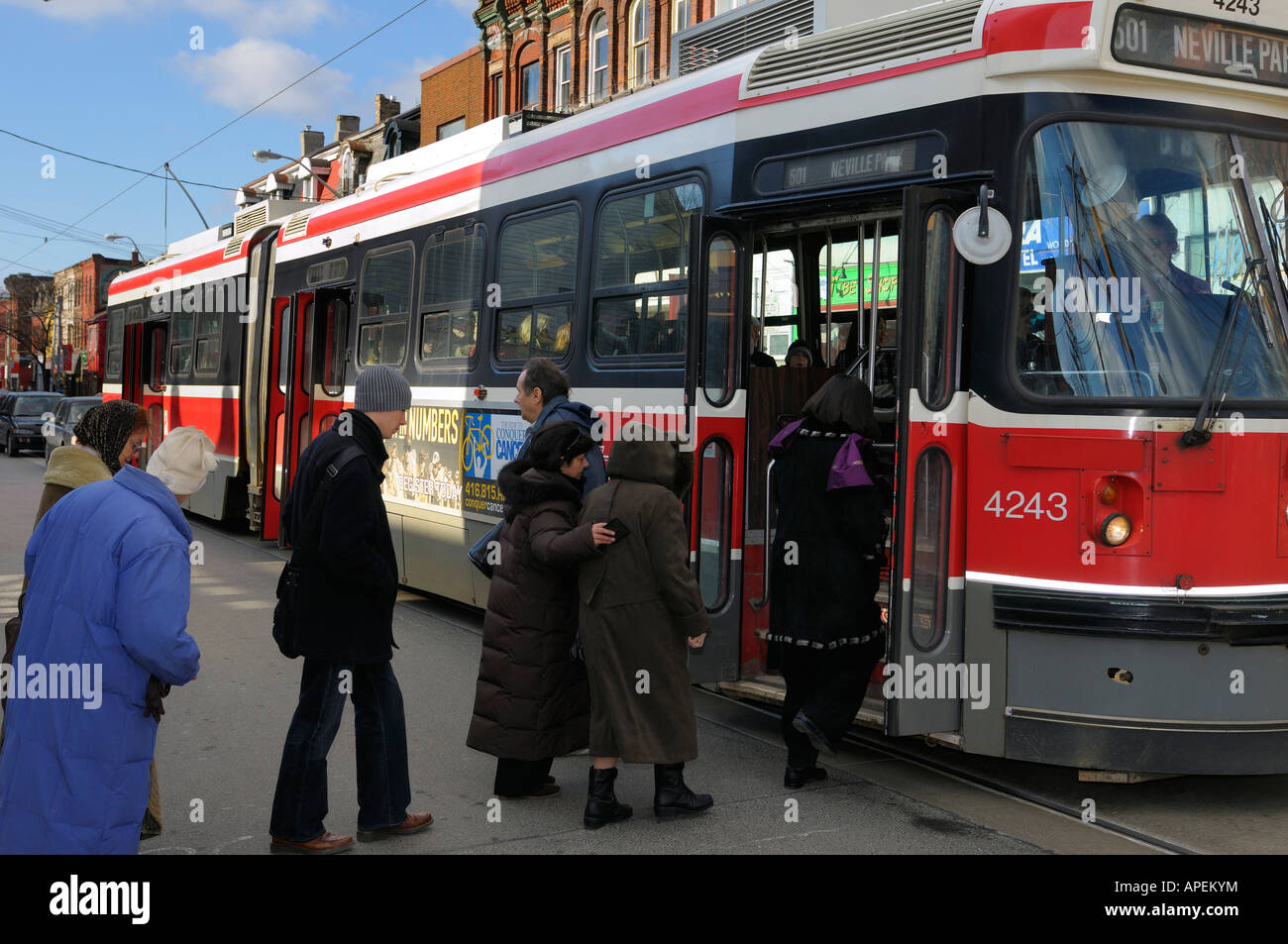Passengers lined up to get on the TTC Queen Streetcar in Toronto in ...