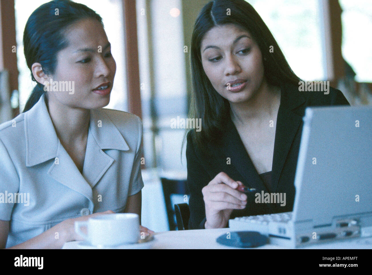 Latino and Asian business women have lunch meeting Stock Photo - Alamy