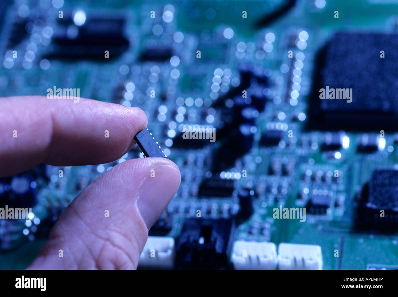 Fingers hold up a chip from a computer board Stock Photo - Alamy