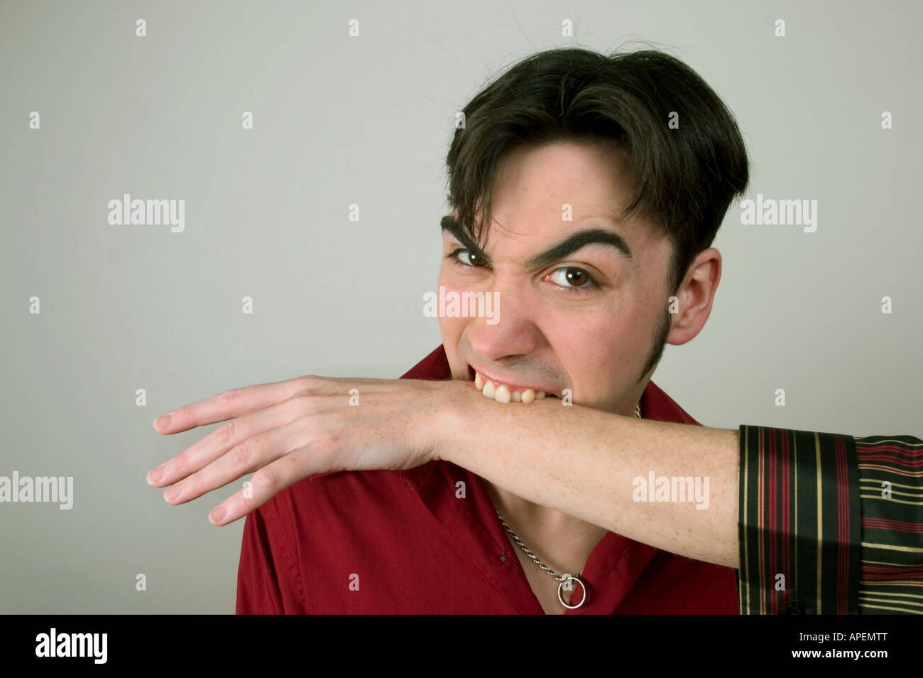 Young man biting a woman's arm. Released Stock Photo - Alamy