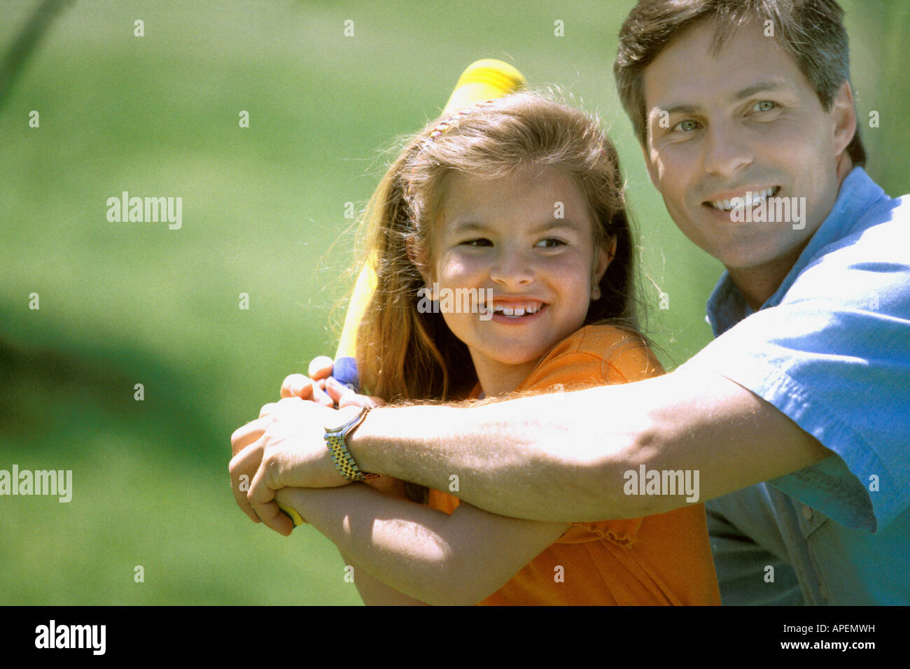 Father showing daughter how to play baseball Stock Photo - Alamy