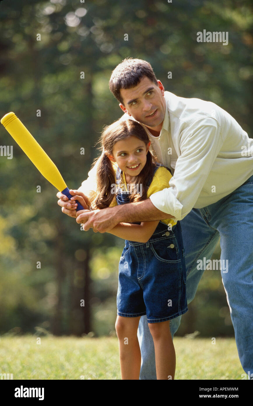 Father showing daughter how to play baseball Stock Photo - Alamy
