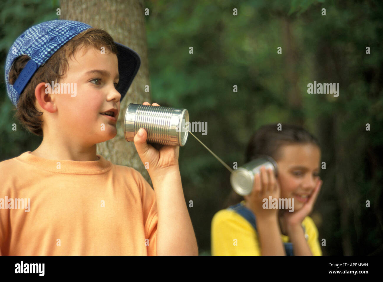 Children playing tin cans hi-res stock photography and images - Alamy