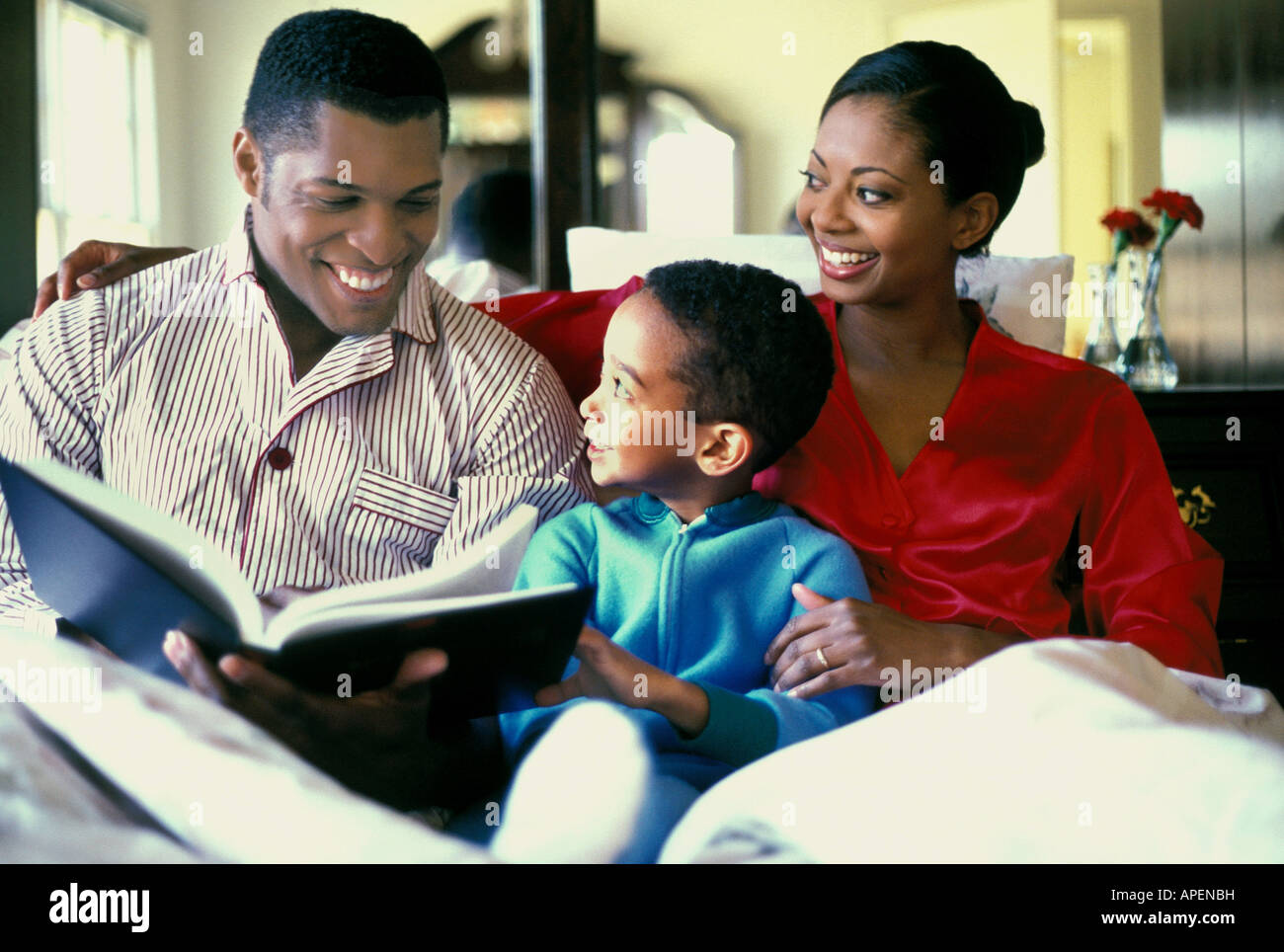 Family reading together in bed Stock Photo - Alamy