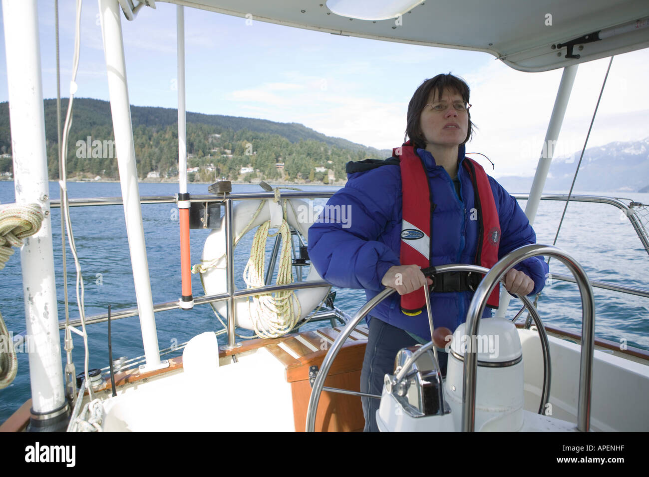 Woman at the Helm of a Sailboat Stock Photo - Alamy