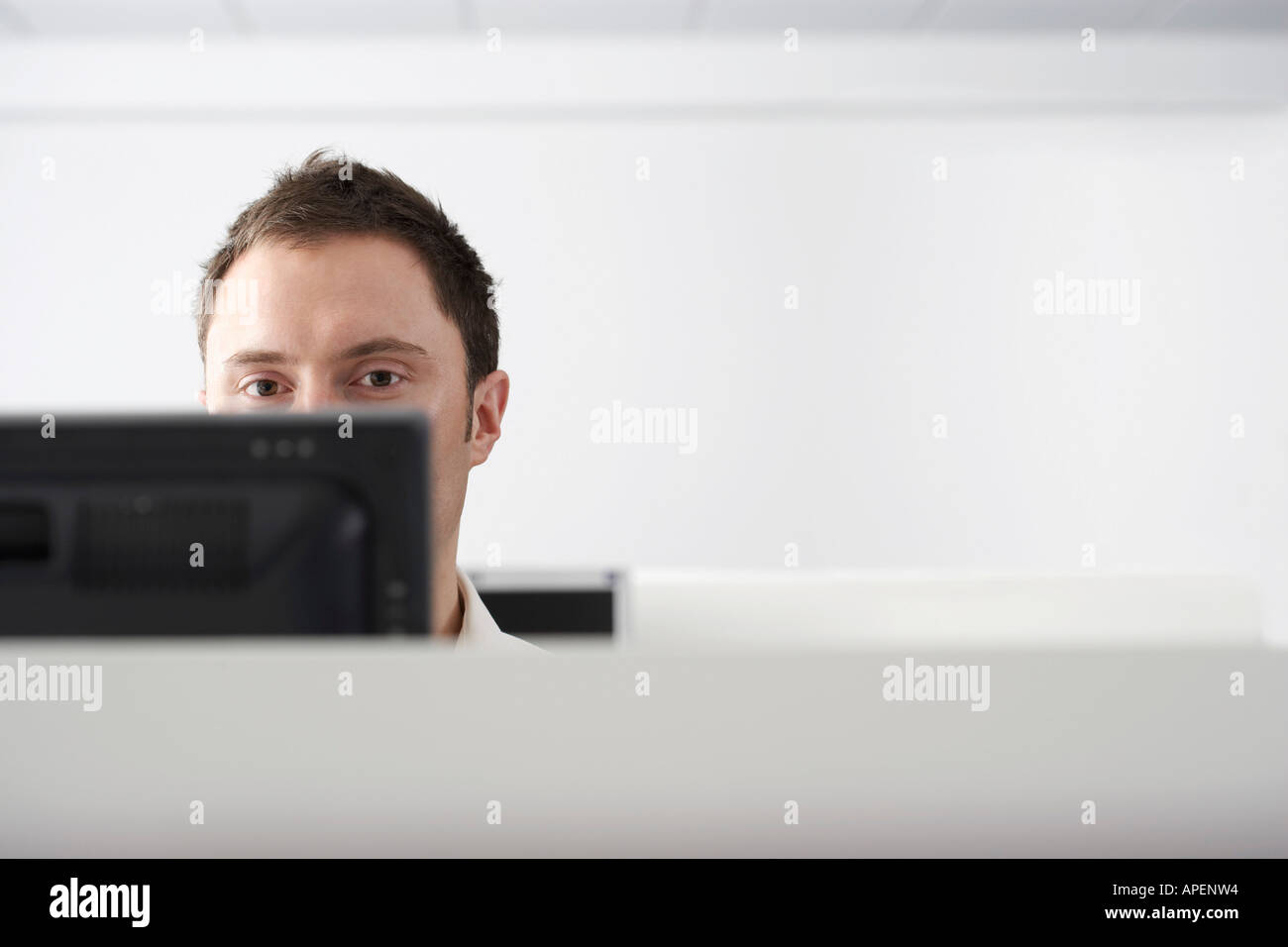 Office worker using computer in office cubicle Stock Photo - Alamy