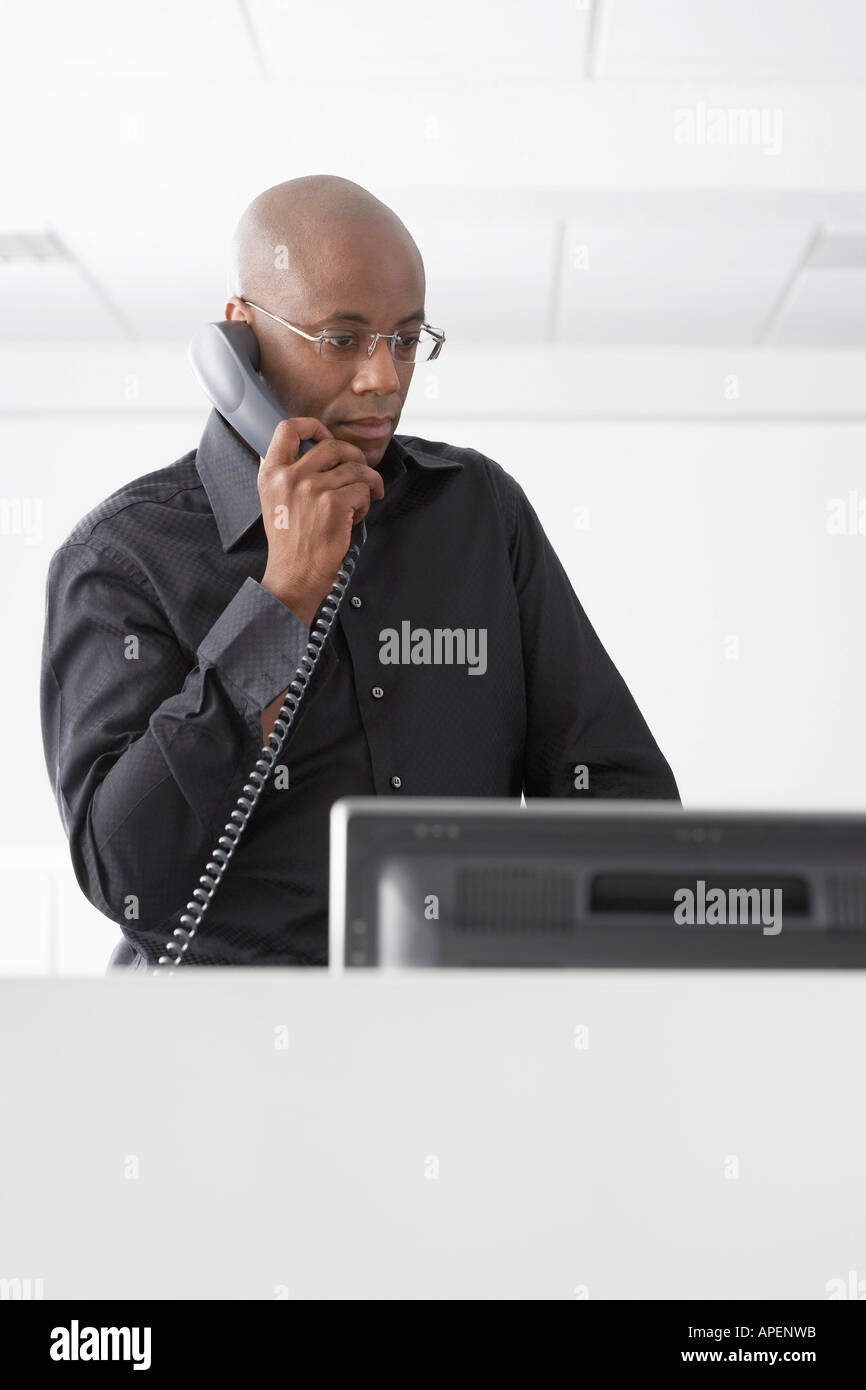 Office worker standing in office, using telephone Stock Photo - Alamy