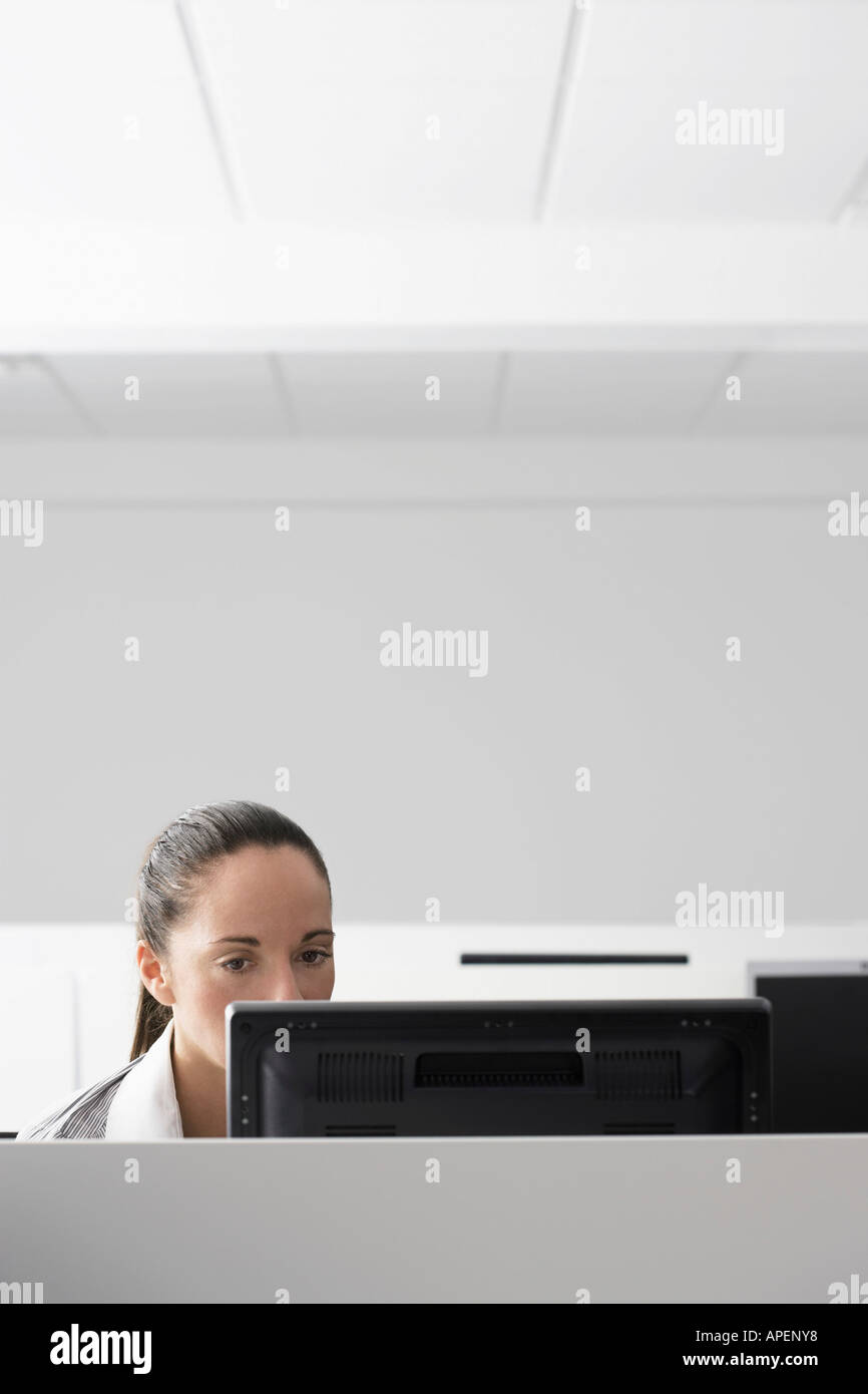 Female office worker using computer in office cubicle Stock Photo - Alamy