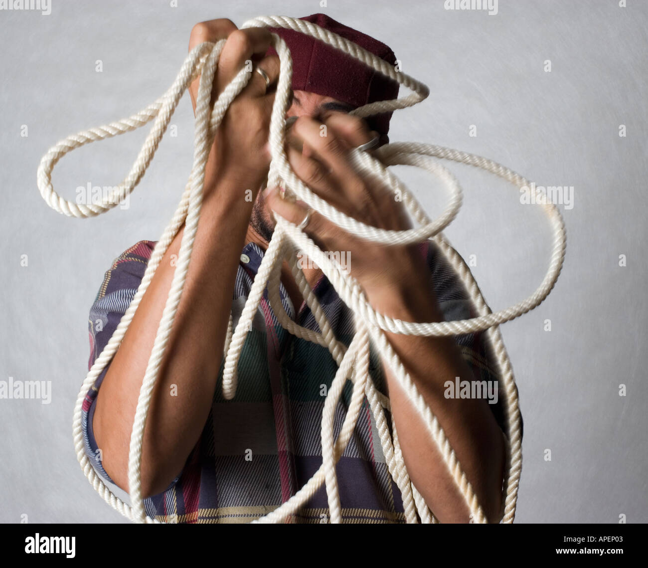 Man frustrated with it tangled rope Stock Photo - Alamy