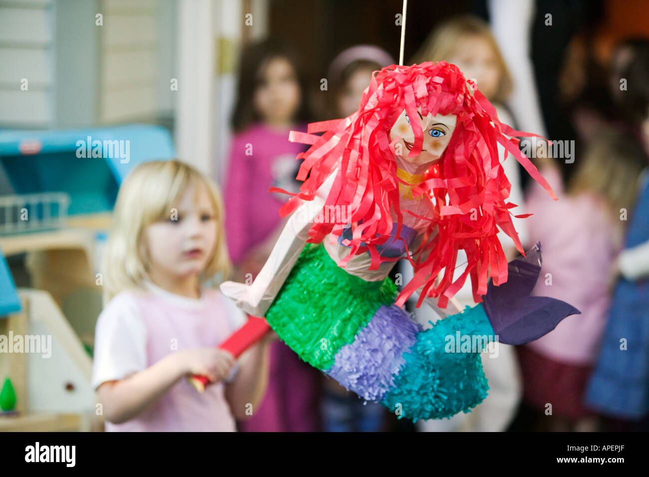Children Trying to Break Open a Pinata at a Birthday Party Stock Photo ...