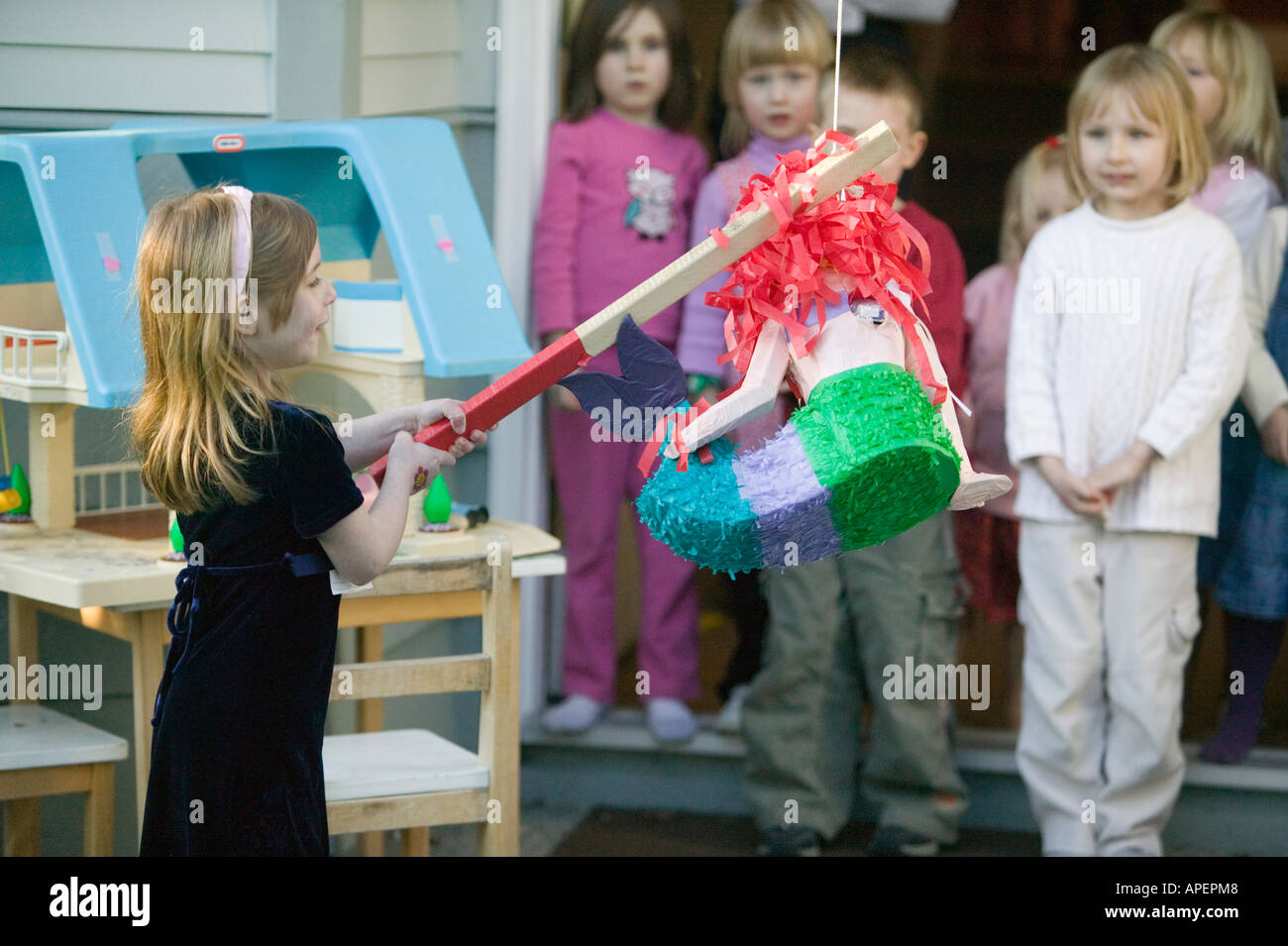 Children Trying to Break Open a Pinata at a Birthday Party Stock Photo ...