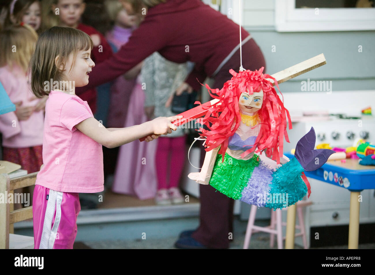 Children Trying to Break Open a Pinata at a Birthday Party Stock Photo ...
