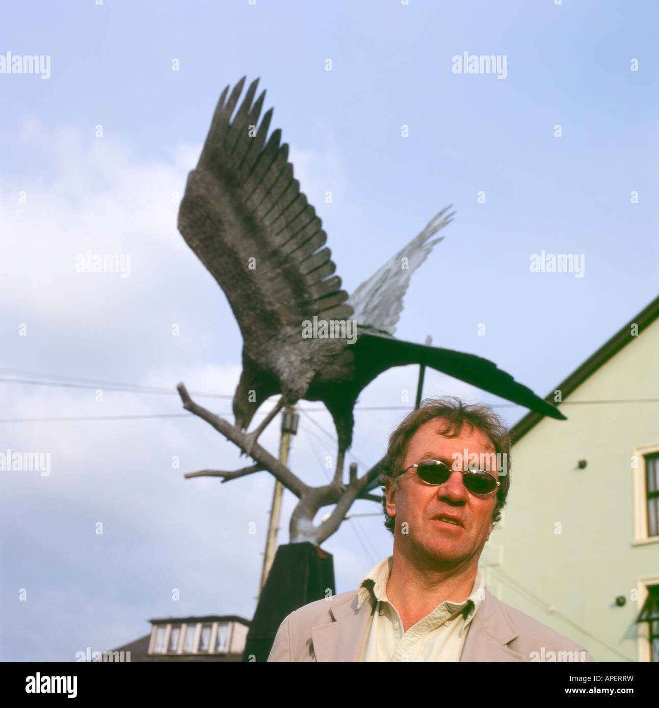 British climber and writer Jim Perrin standing by statue of red kite ...