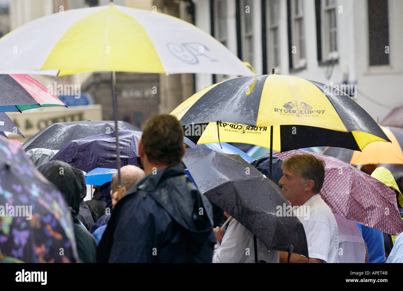 People shelter under umbrellas during heavy rain at the annual Brecon ...