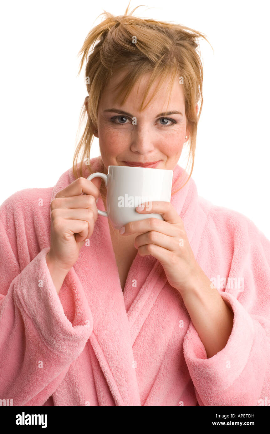 Studio shot of woman in pink robe with coffee mug Stock Photo - Alamy