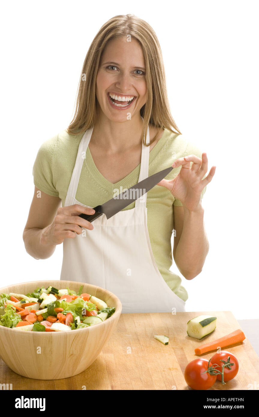Studio shot of woman making salad Stock Photo - Alamy