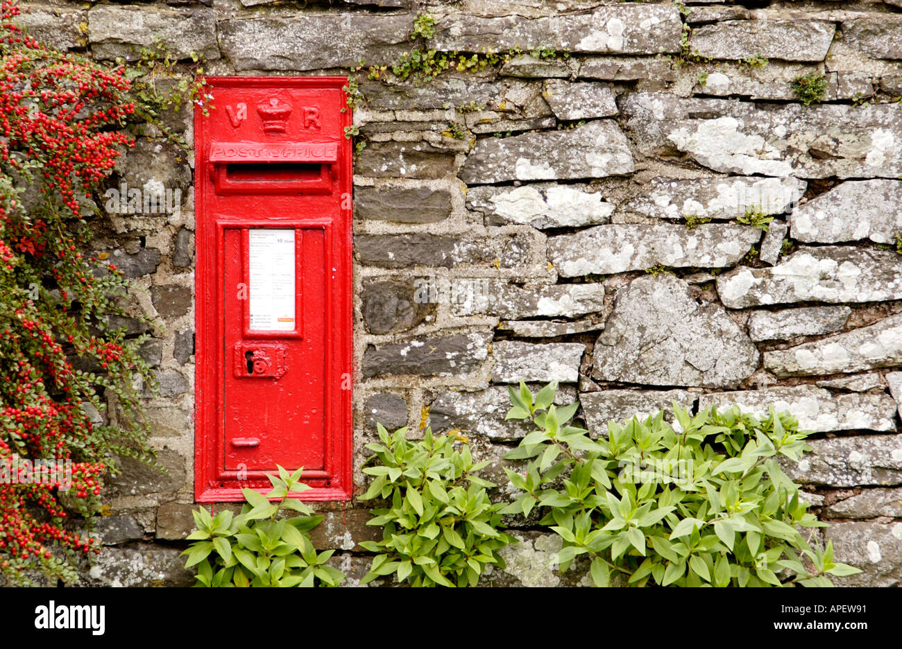 Victorian red post box set in a stone wall at Crickadarn Powys Mid ...