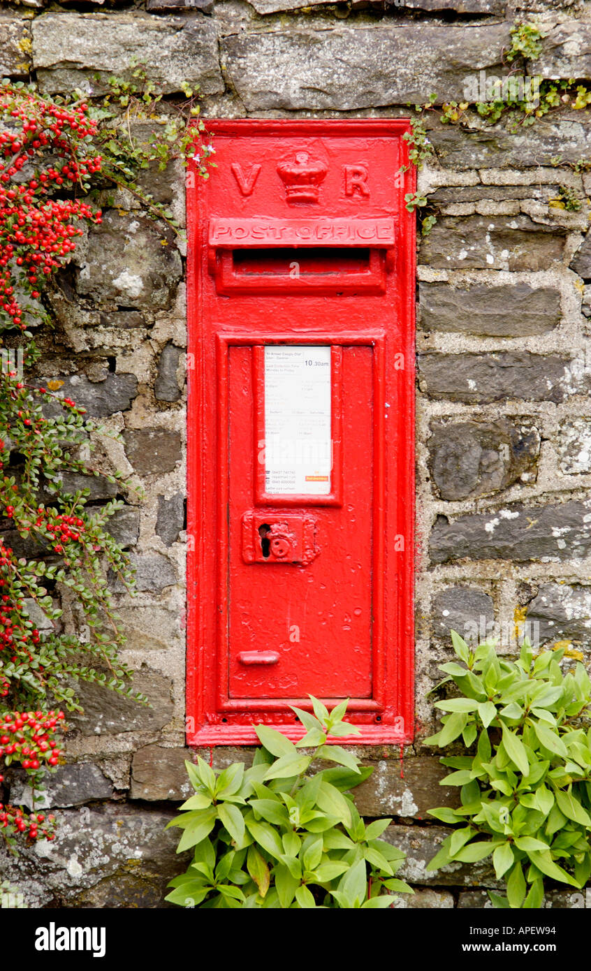 Victorian red post box set in a stone wall at Crickadarn Powys Mid ...
