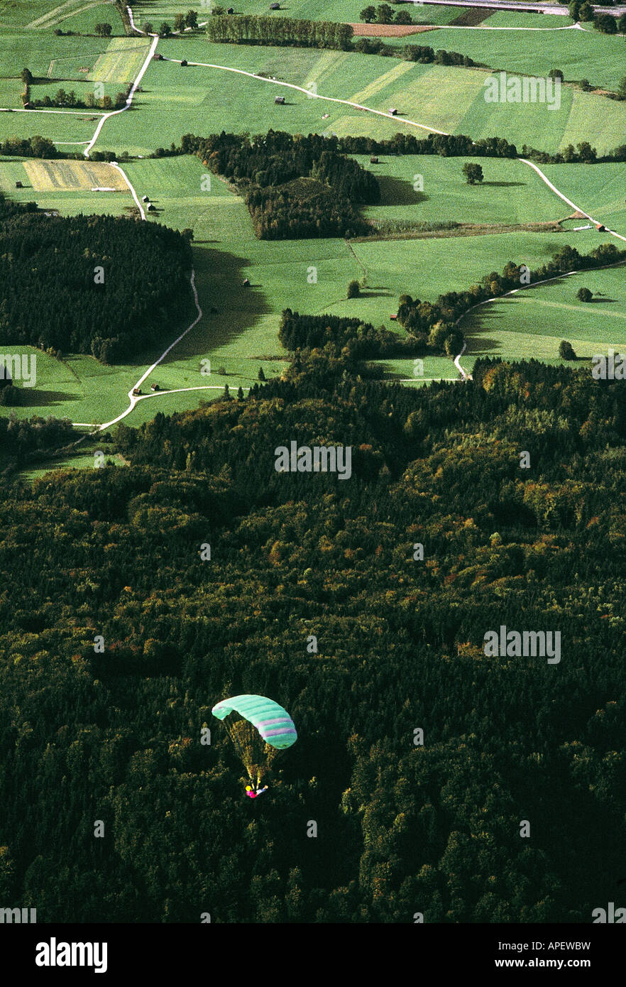 Parasailer soaring above green valley in background. (Austrian Tyrol ...