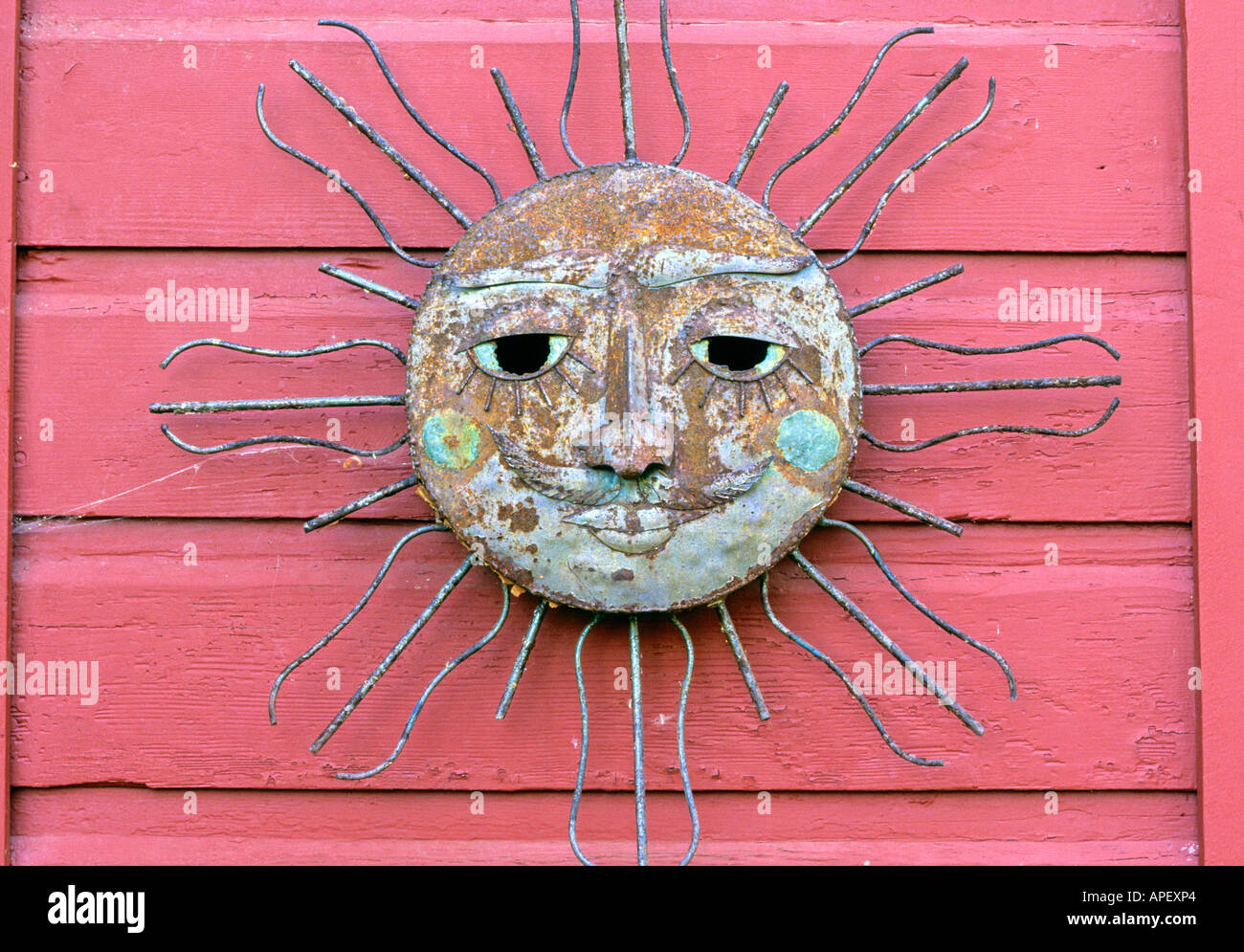 Metal Sun face rust wall siding maroon Stock Photo - Alamy