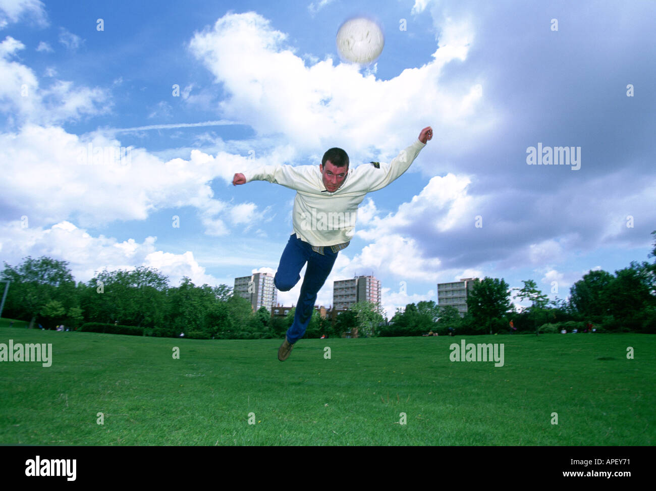 Football action man in air after flying header Stock Photo - Alamy