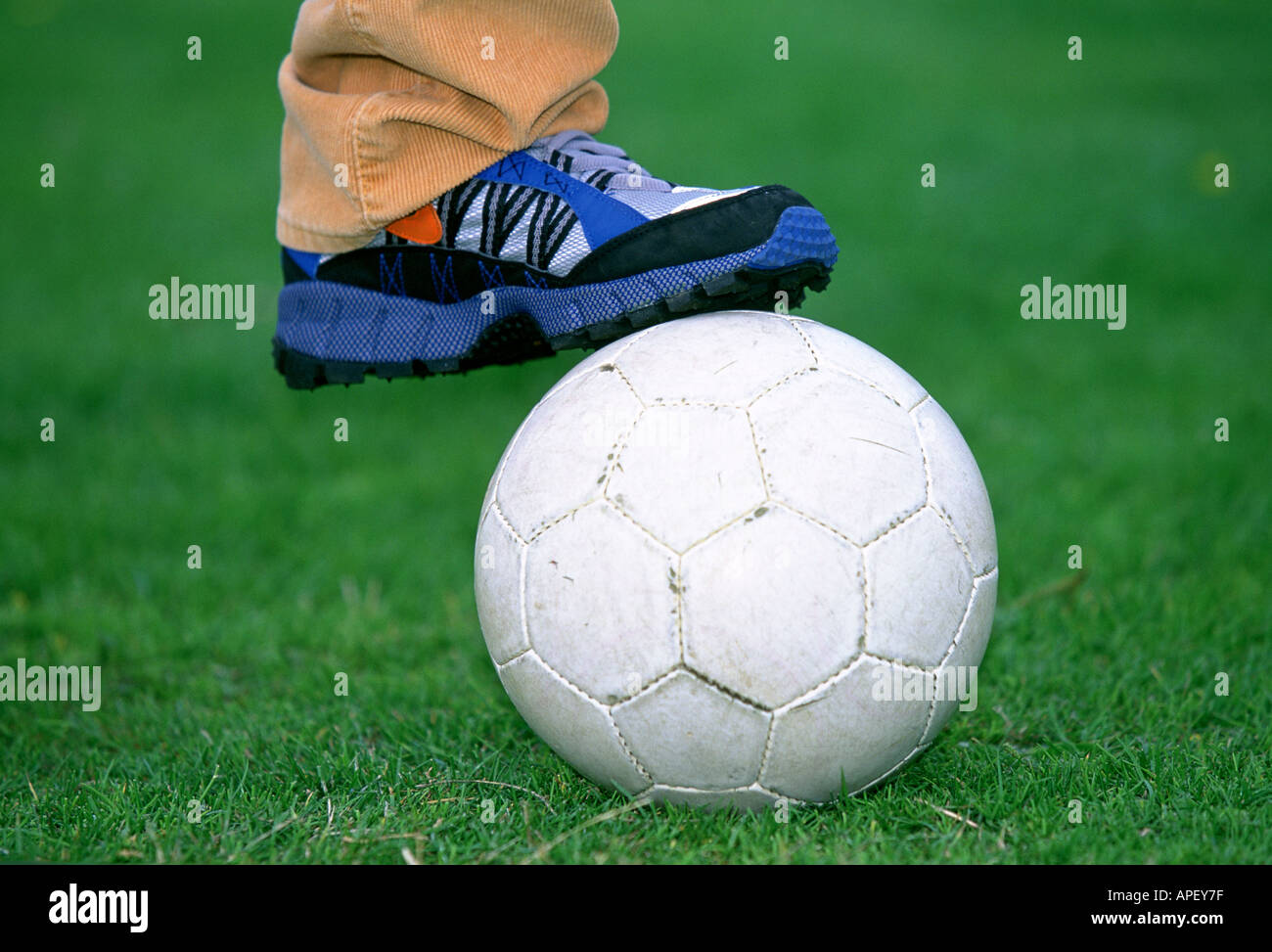 Sports shoe balanced on soccer foot ball Stock Photo - Alamy