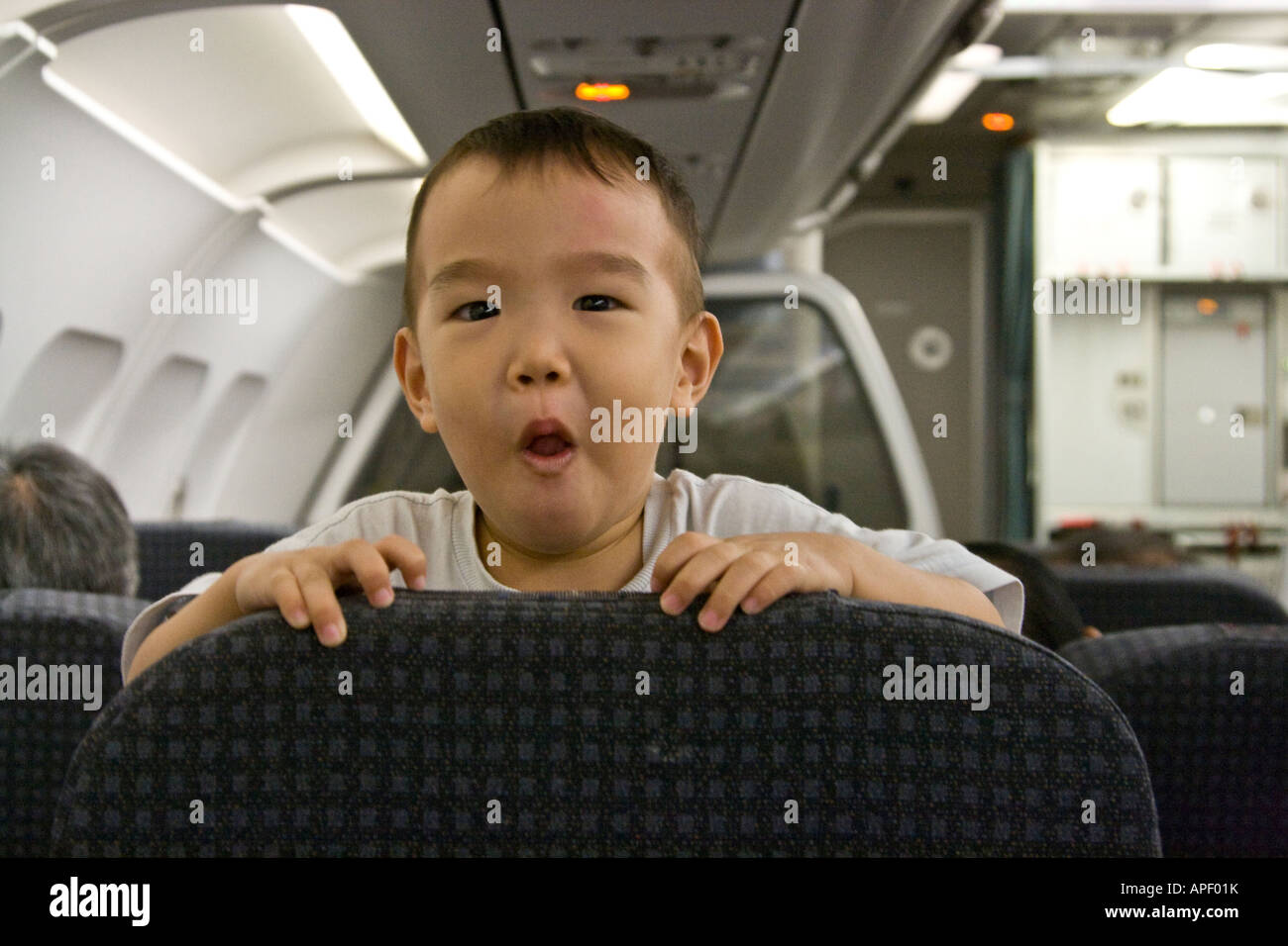 Surprised Young Chinese Boy in an Airplane Stock Photo - Alamy