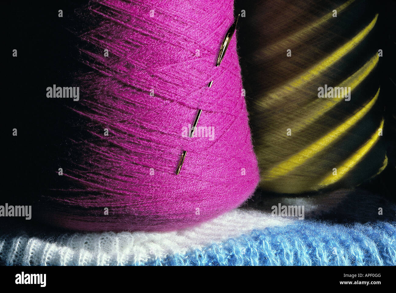 Cotton string rolls, magenta and yellow with thick metal needle. Blue ...