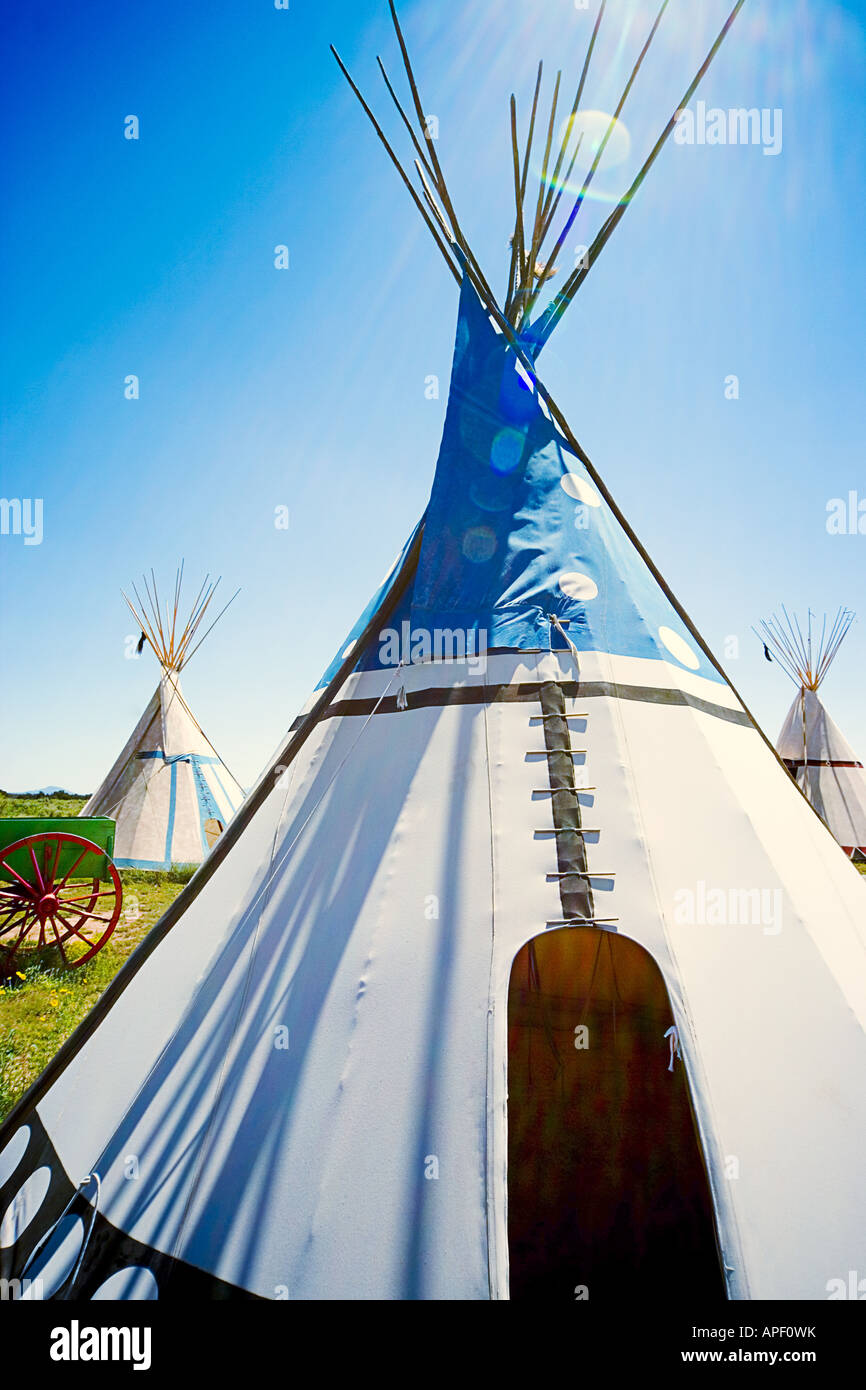 Indian teepees in a field with wagon in background Stock Photo - Alamy