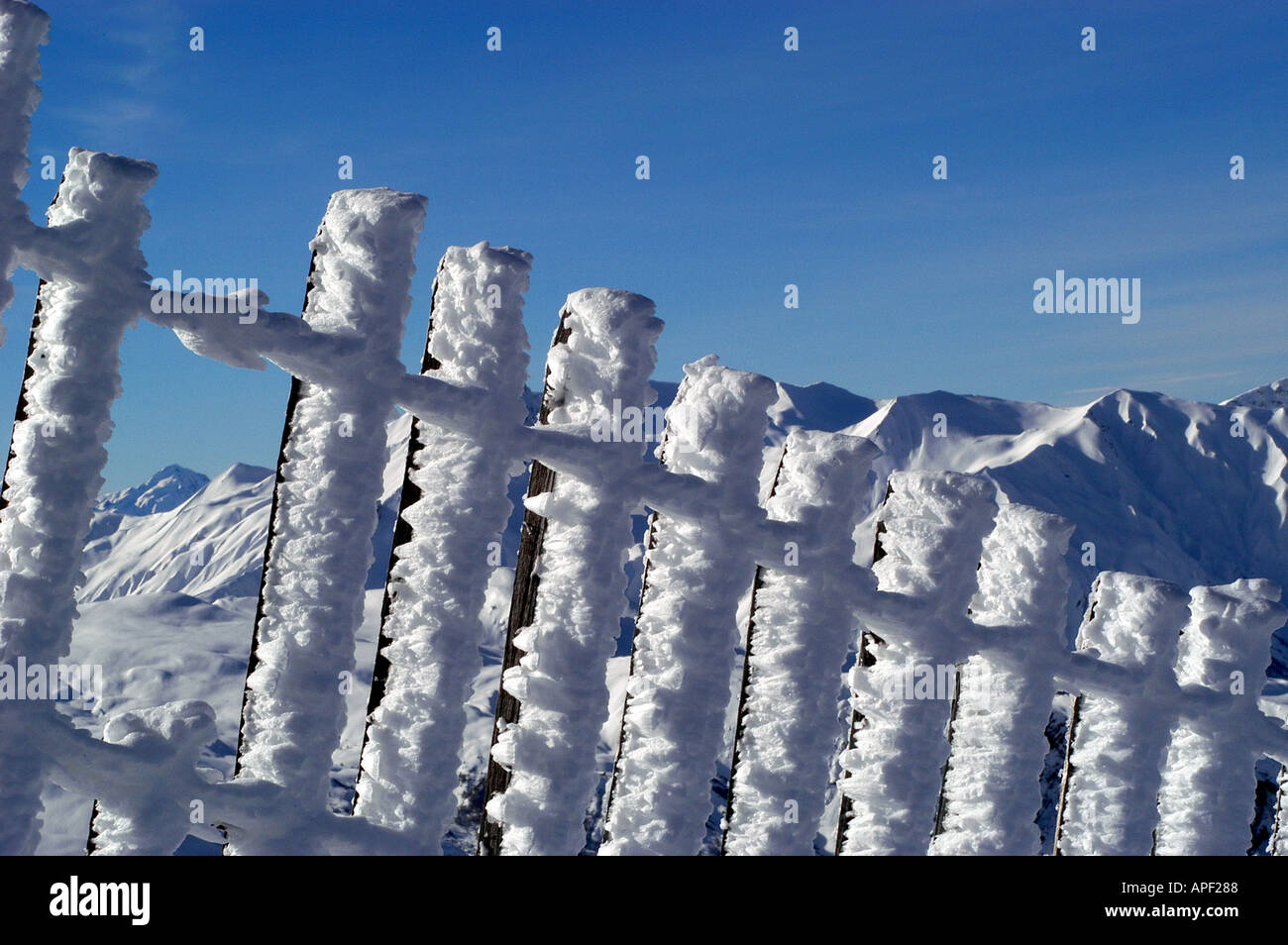 Snow and ice on mountain fence Stock Photo - Alamy