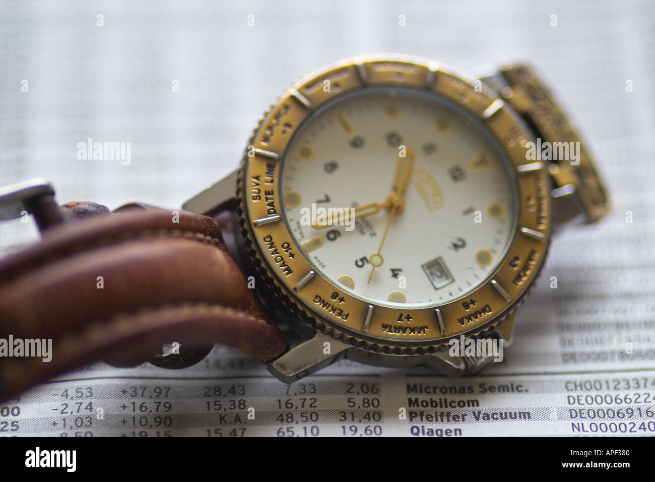 Watch on a newspaper Stock Photo - Alamy