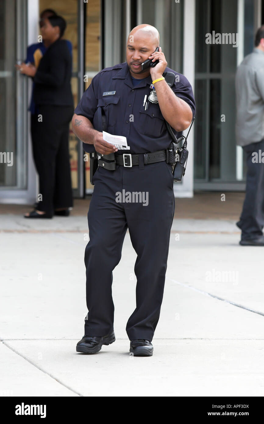 A Detroit police officer talking on a cell phone Stock Photo - Alamy