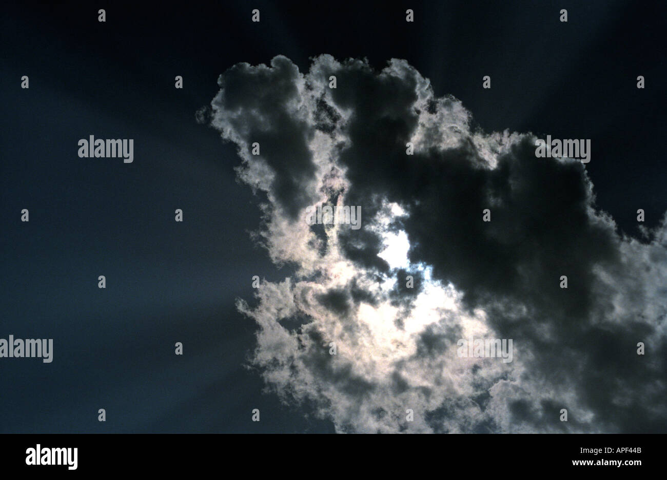 Sun emerging from clouds Stock Photo - Alamy
