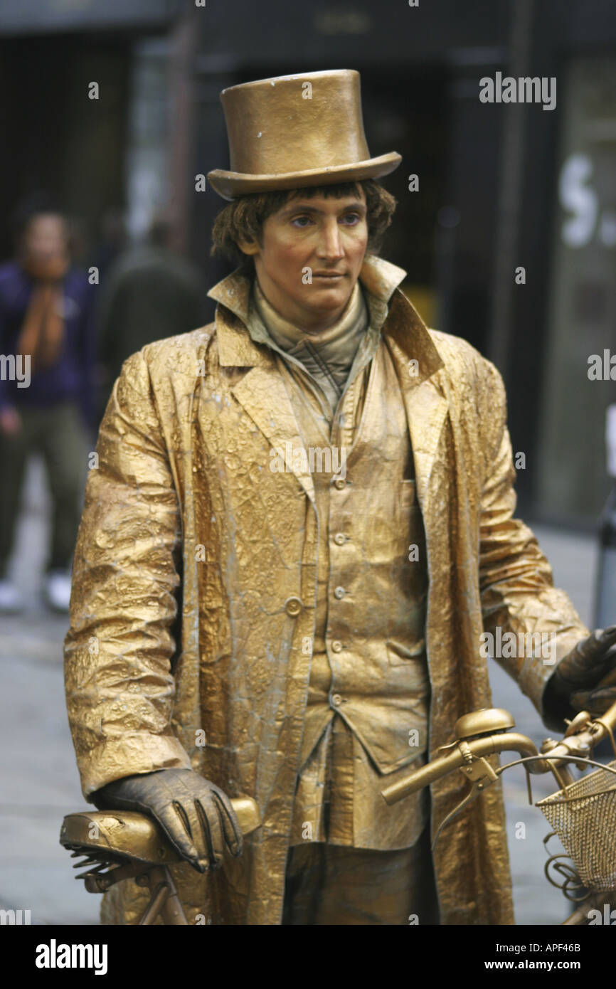 Street performer human statue gold male top hat Stock Photo - Alamy