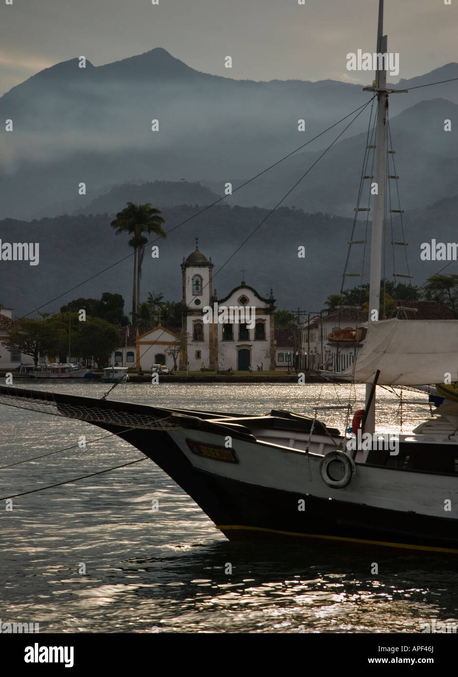 Boat moored in Paraty, with Santa Rita church in background. Rio de ...