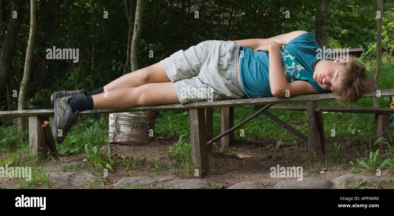 Boy sleeping on bench hi-res stock photography and images - Alamy