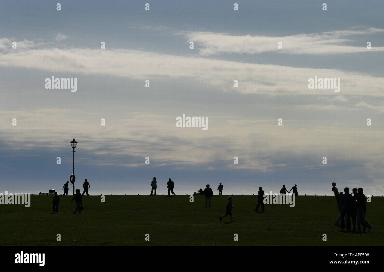 silhouettes of families on promenade at sun down lytham lancashire ...