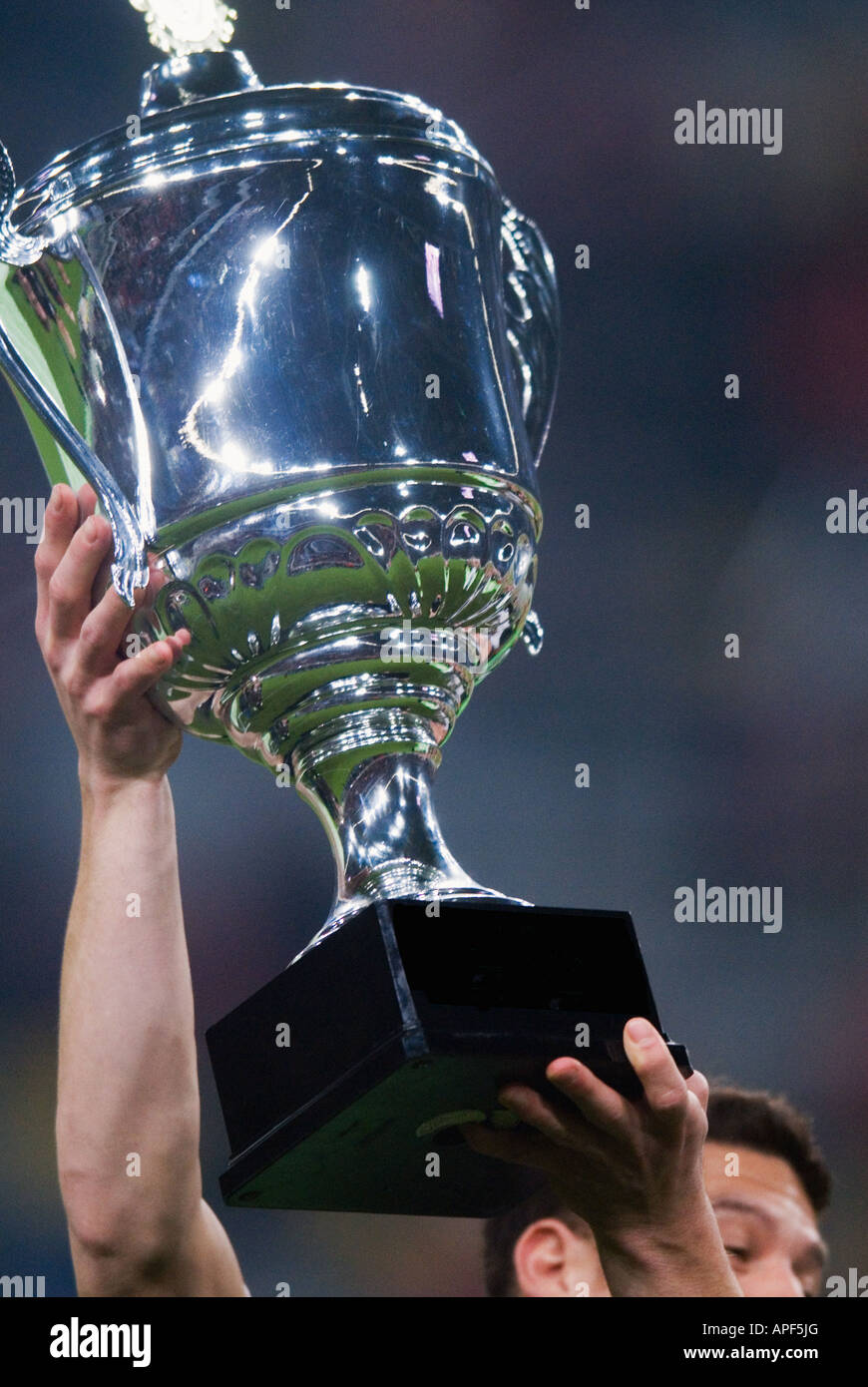 Player is rising up a soccer trophy Stock Photo - Alamy