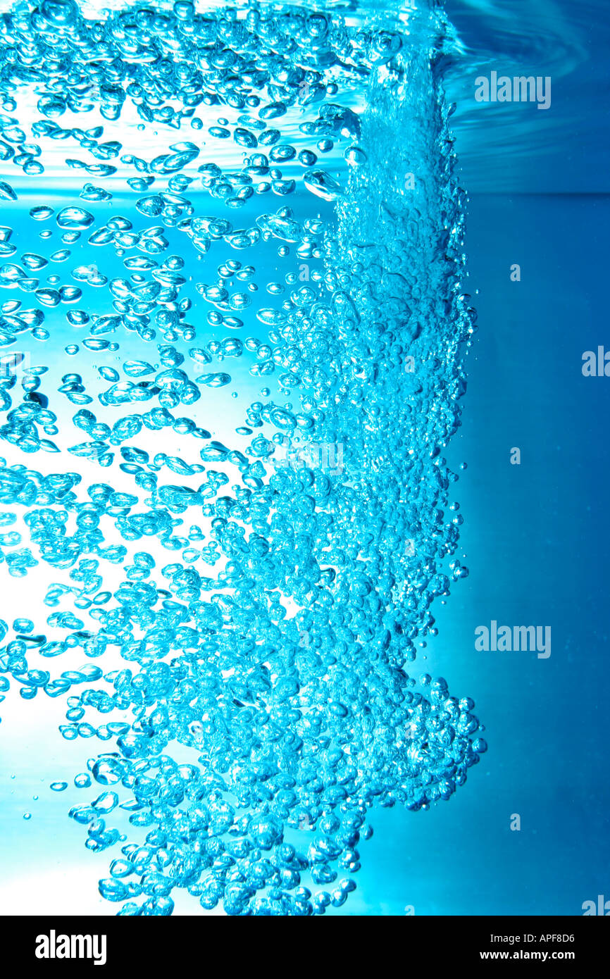 air bubbles water jet gets through water surface Stock Photo - Alamy