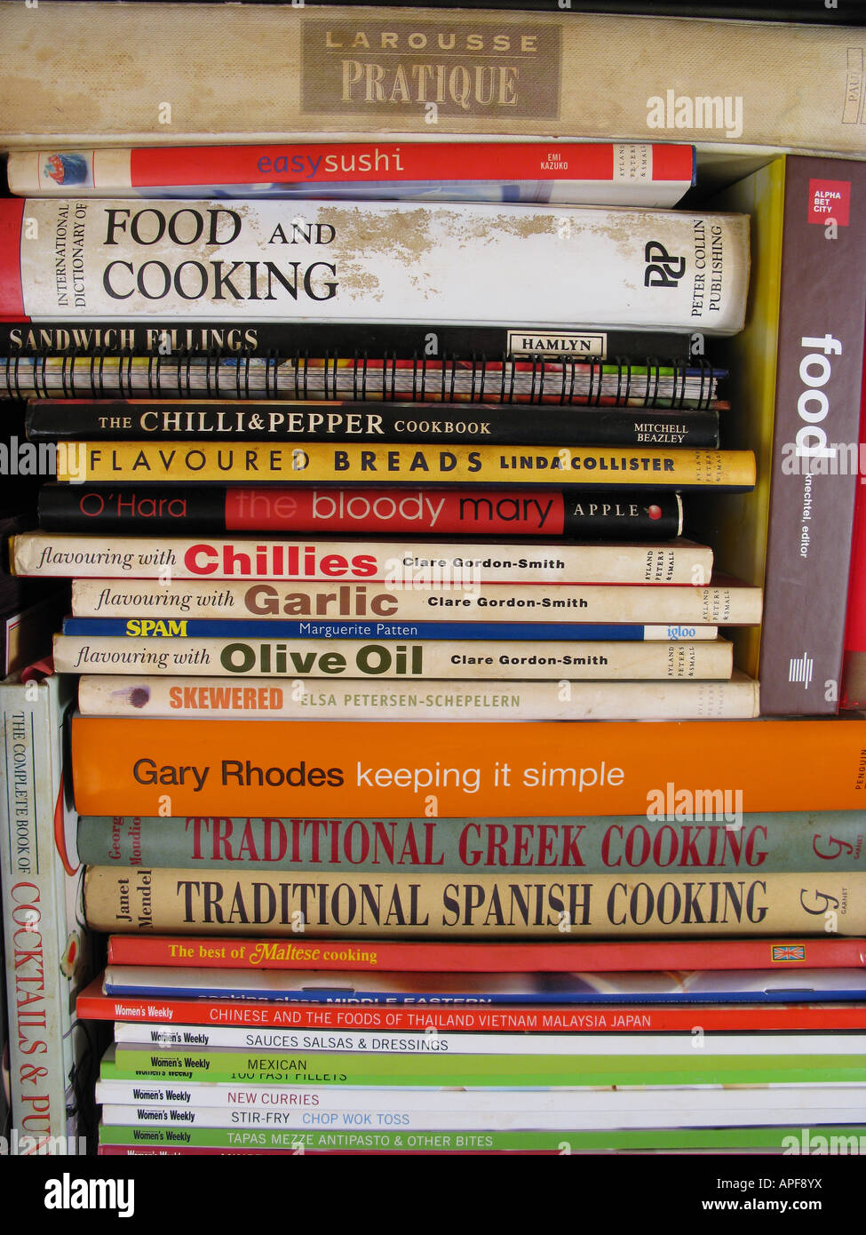Pile of cookery books on bookshelf Stock Photo - Alamy