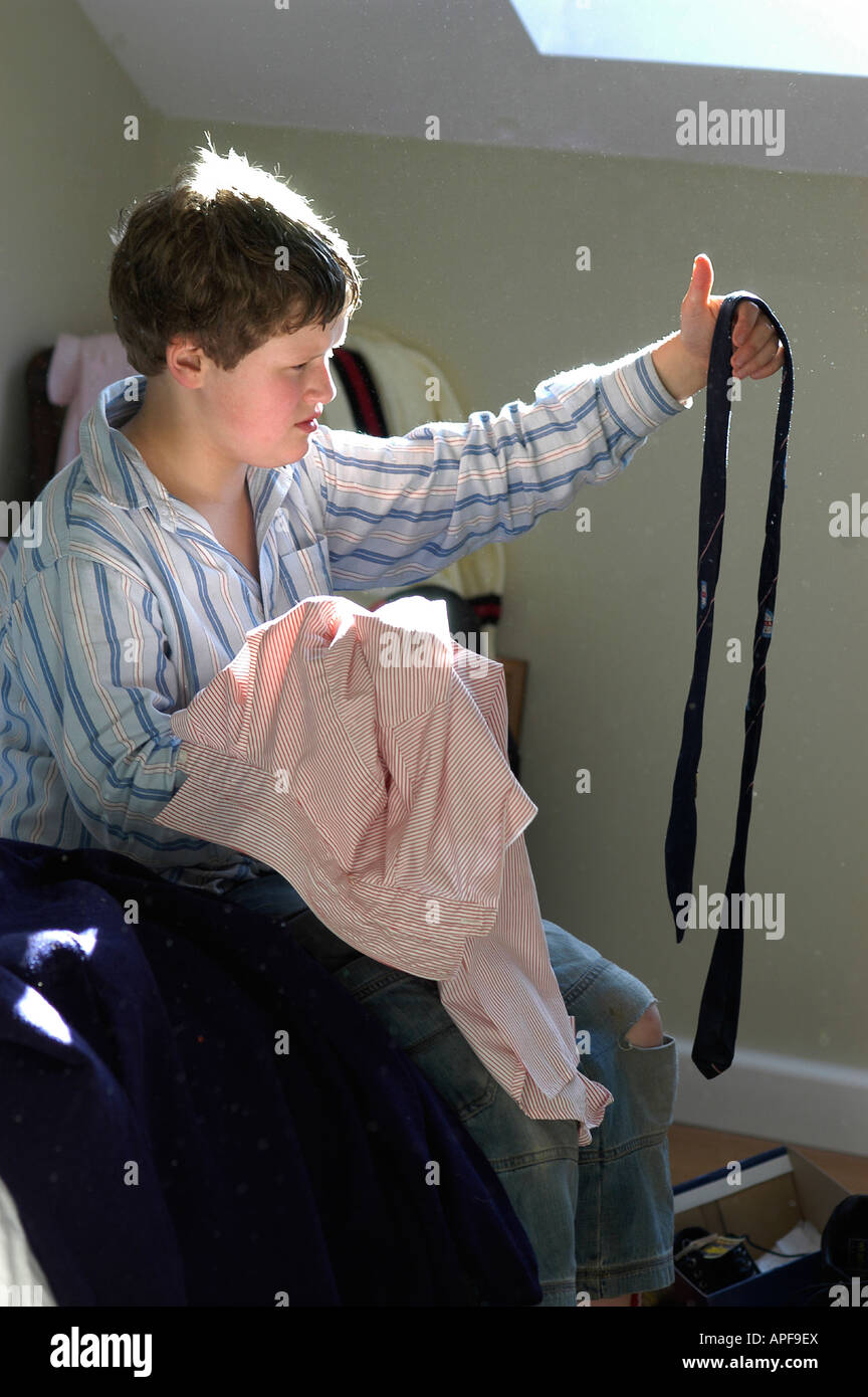 boy iooking fed up with new school uniform Stock Photo - Alamy