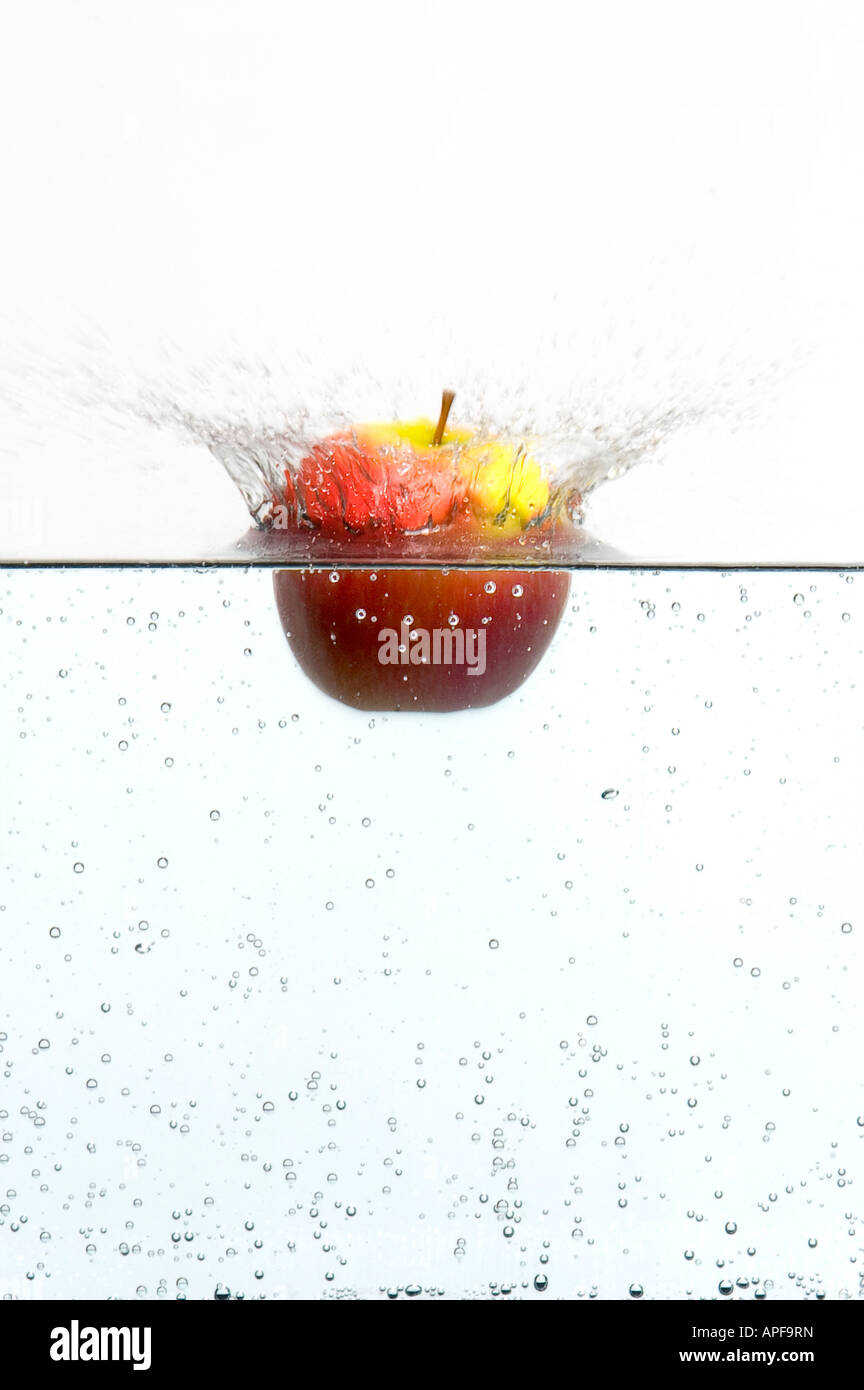 Apple splashing dropping into fizzy carbonated water Stock Photo - Alamy