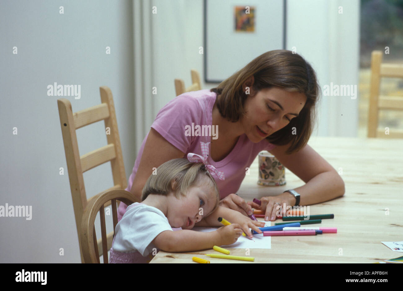 mother helping her child to draw Stock Photo - Alamy