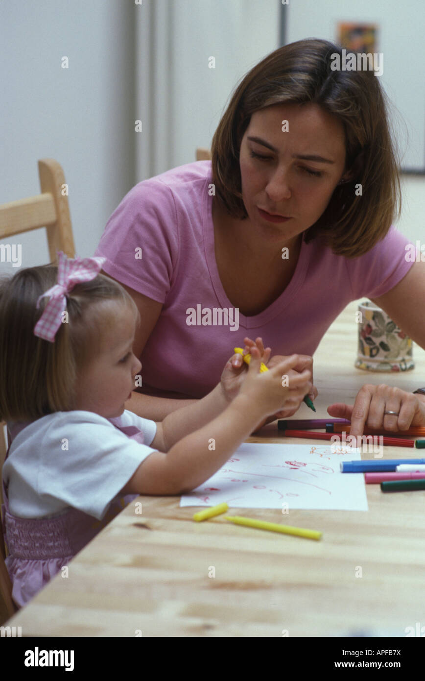 mother helping her child to draw Stock Photo - Alamy