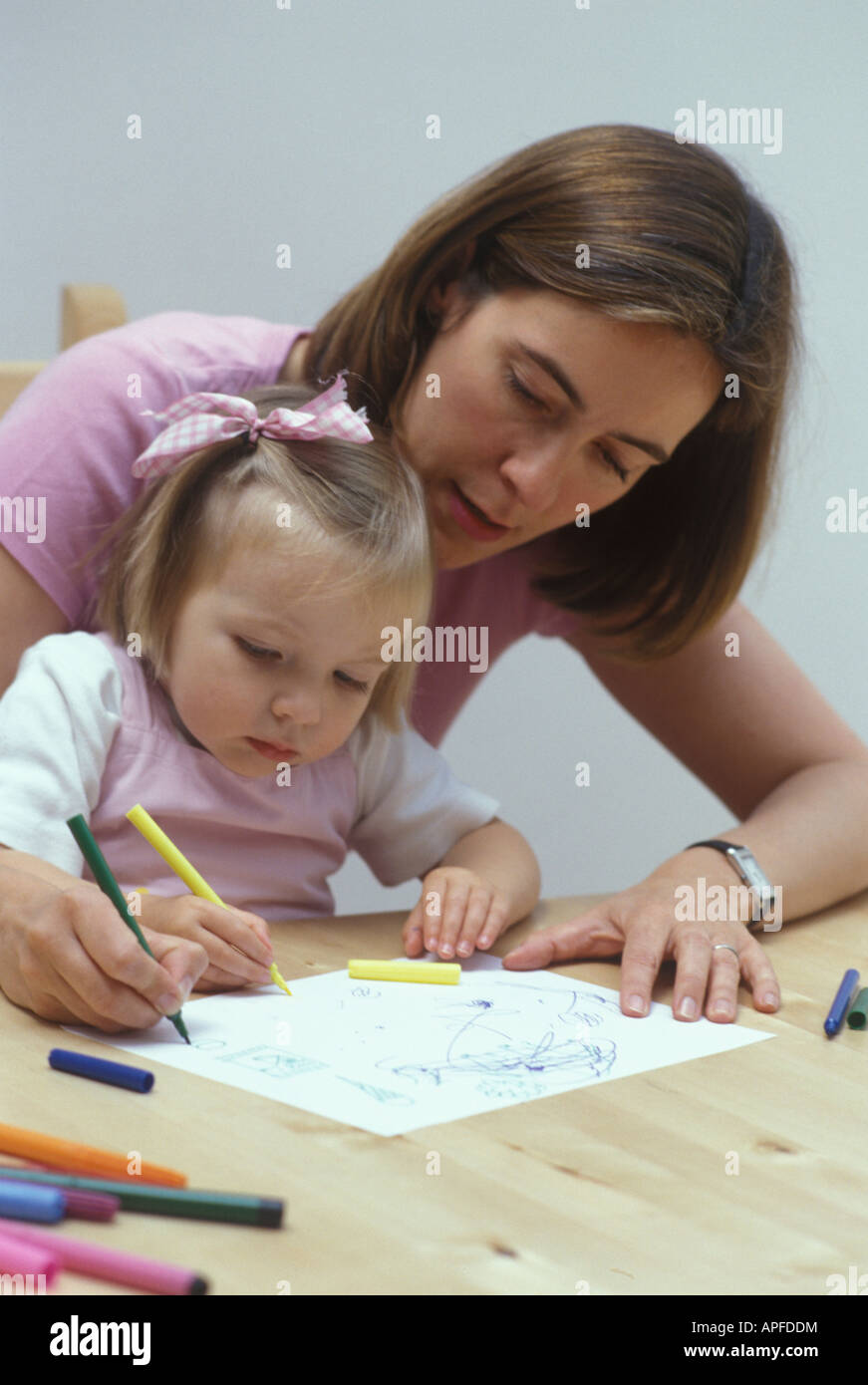 mother helping her child to draw Stock Photo - Alamy