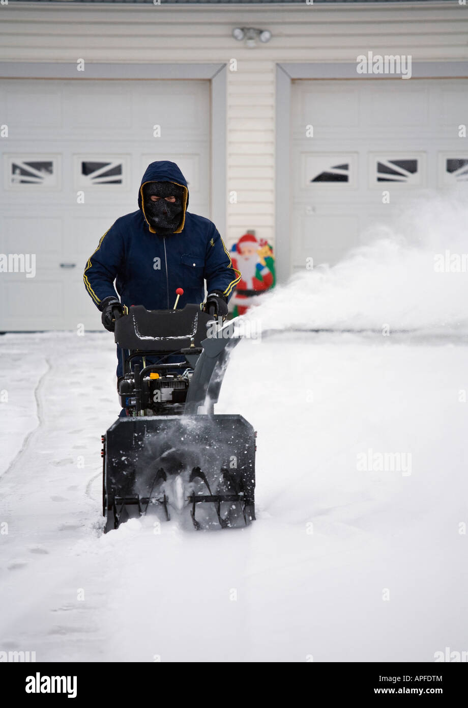 Man operating a snow blower Stock Photo - Alamy