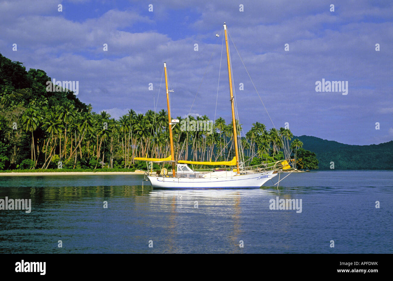 An ocean going sailboat anchors just off the beach on Matagi Island in ...