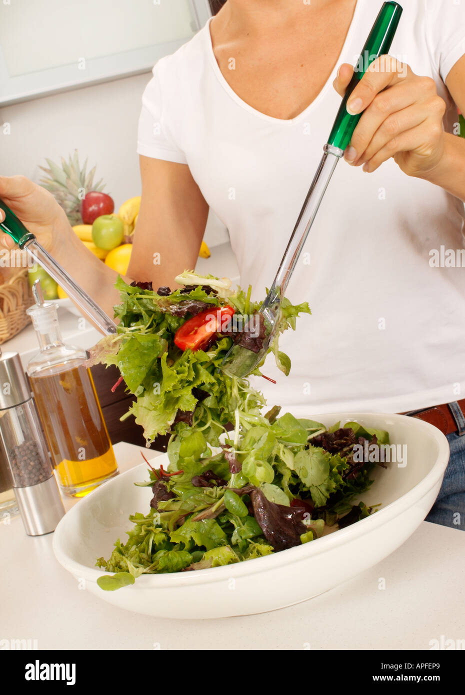 WOMAN IN KITCHEN MAKING SALAD Stock Photo - Alamy