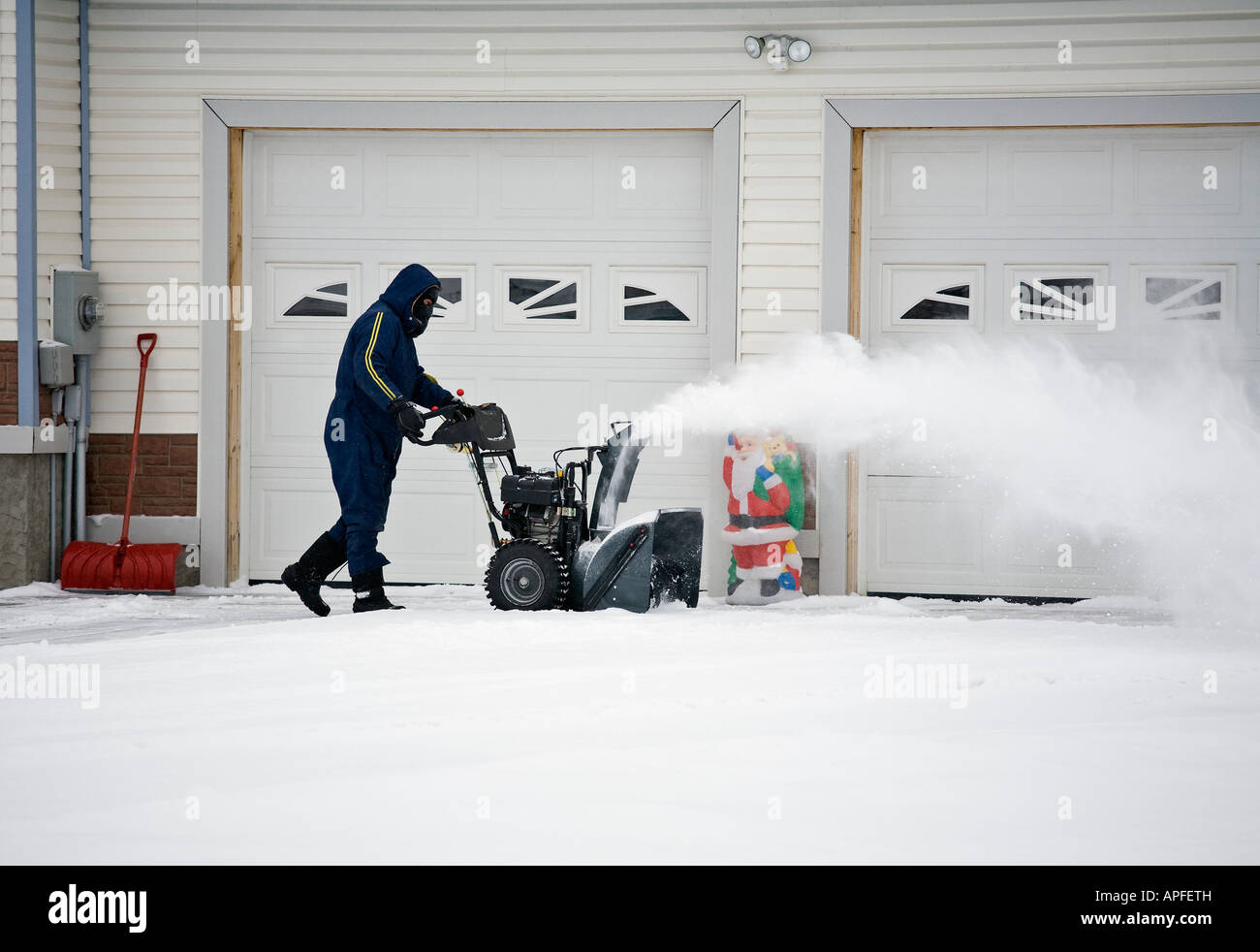 Man operating a snow blower Stock Photo - Alamy